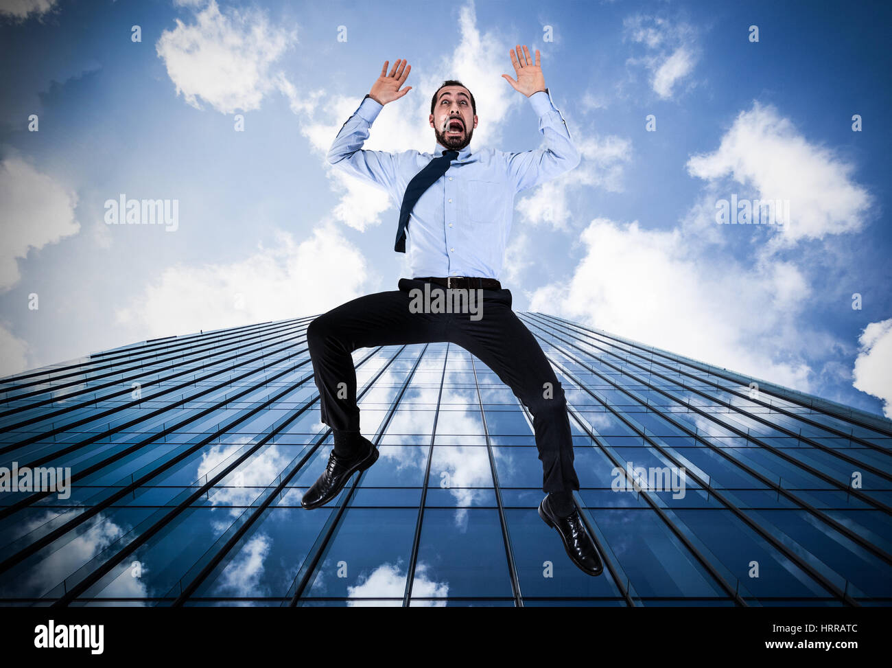 Businessman falling from a skyscraper Stock Photo - Alamy