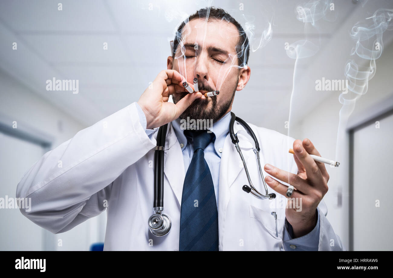 Stressed doctor smoking many cigarettes at the same time Stock Photo ...