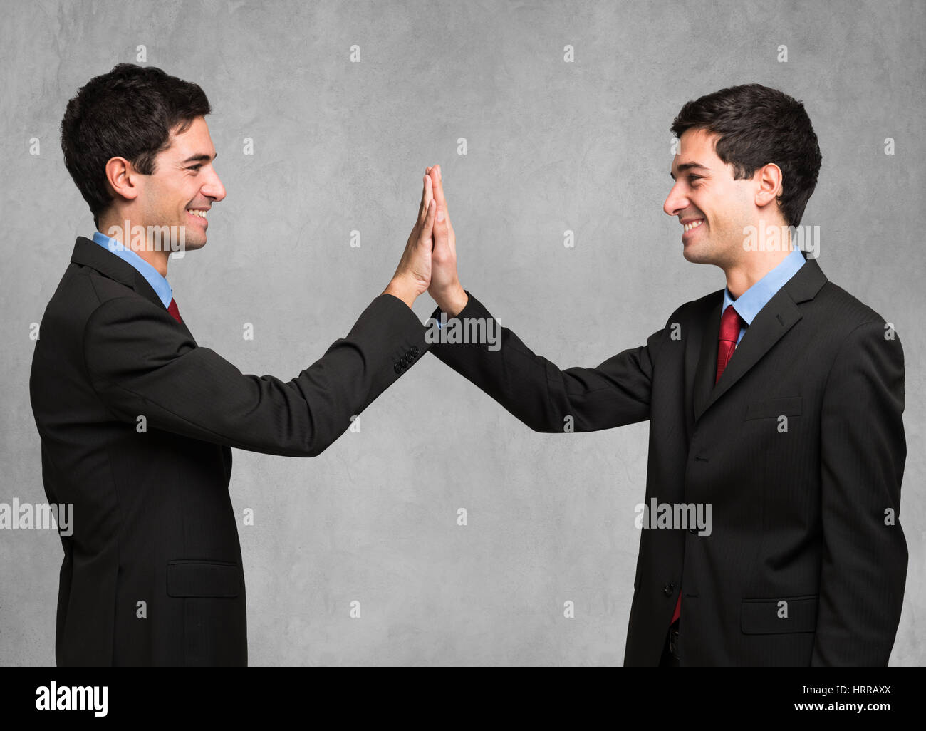 Happy smiling man high fiving to himself Stock Photo - Alamy