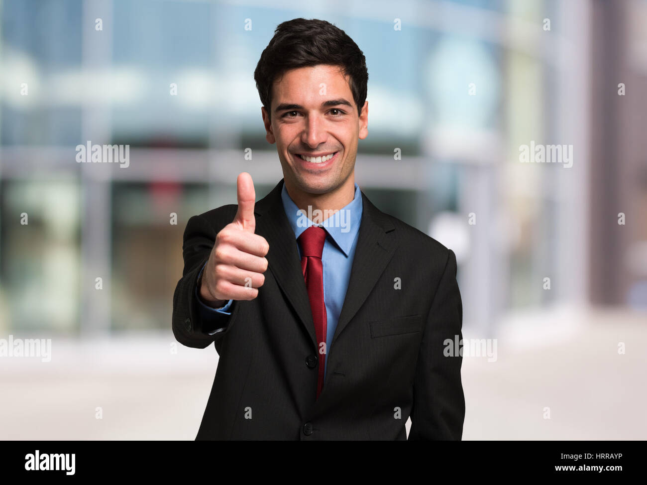 Confident businessman giving thumbs up, business success concept Stock Photo - Alamy