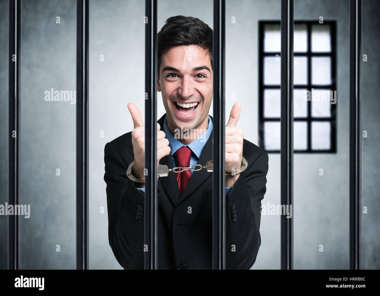 Business man happy to be in prison Stock Photo - Alamy