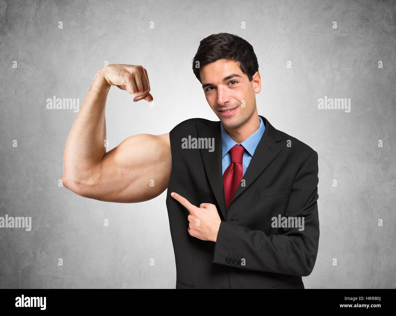 Powerful businessman showing his biceps Stock Photo - Alamy