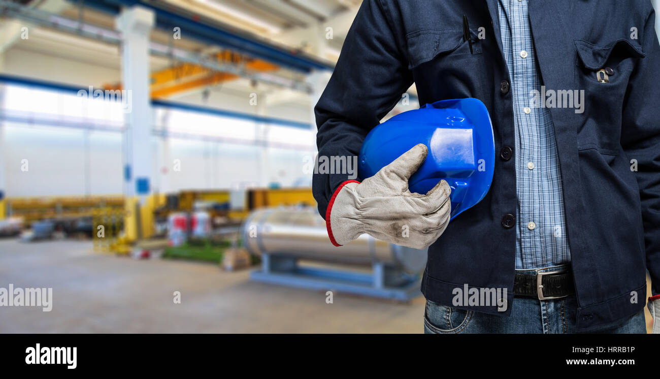 Worker in front of a production site Stock Photo - Alamy