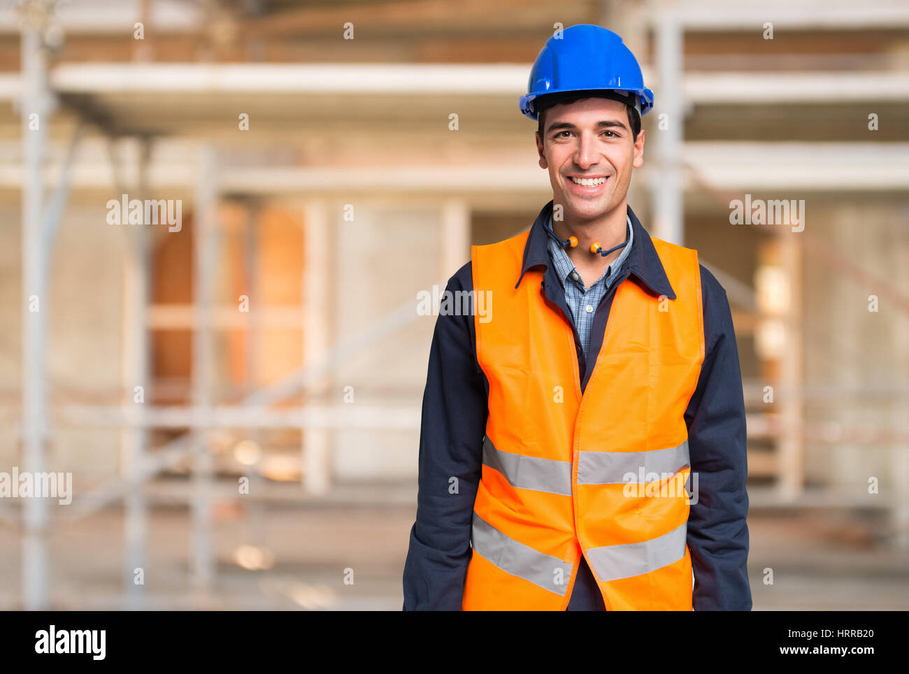 Smiling worker in a construction site Stock Photo - Alamy