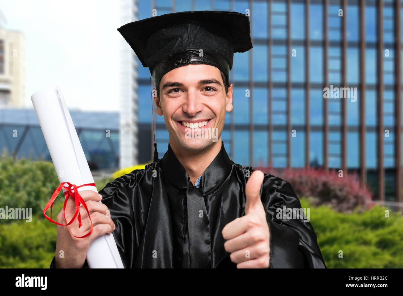 Smiling graduate holding degree hi-res stock photography and images - Alamy