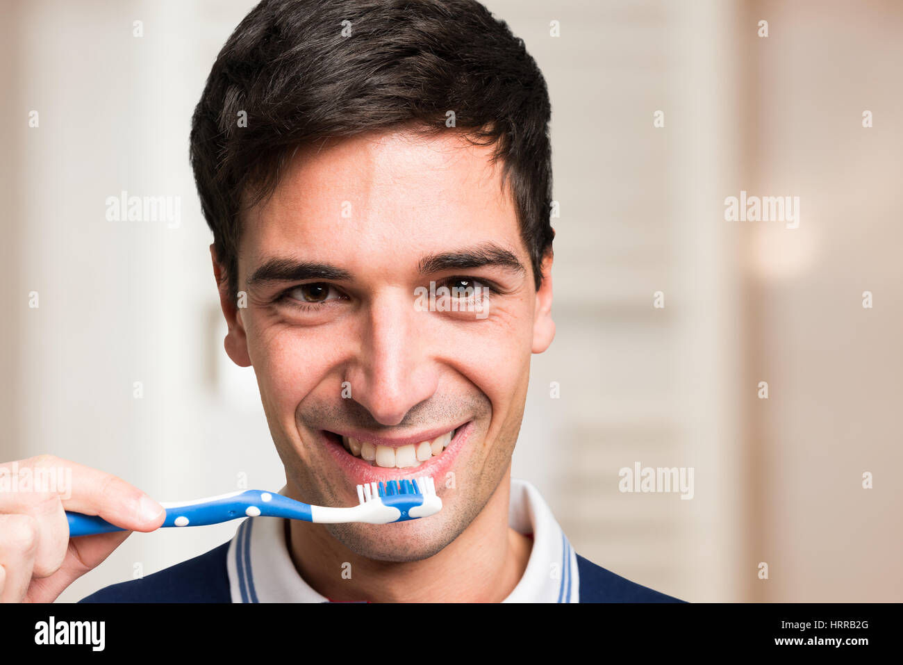 Man brushing his teeth in the bathroom Stock Photo - Alamy