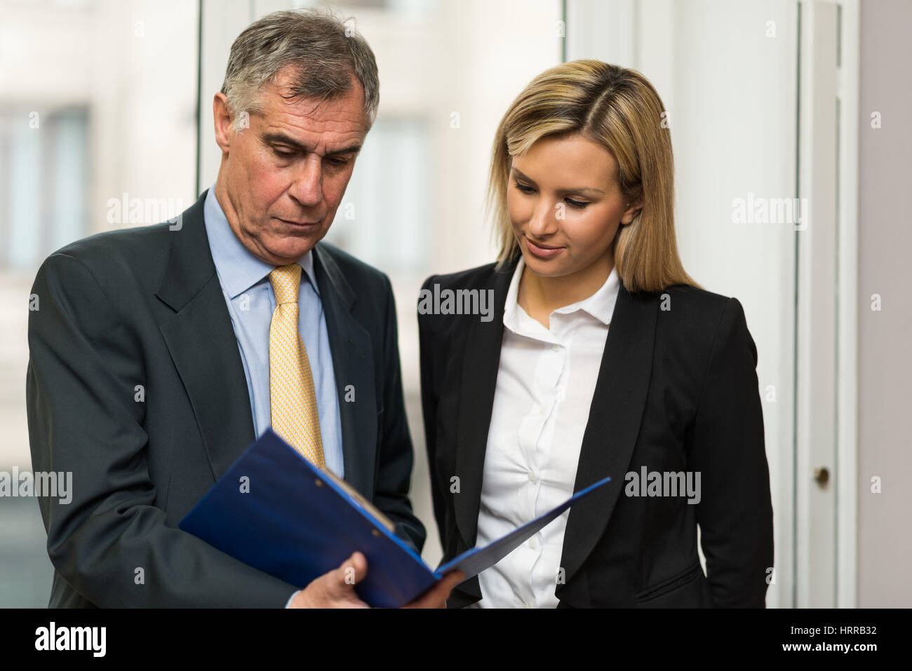 Business people reading a document Stock Photo - Alamy