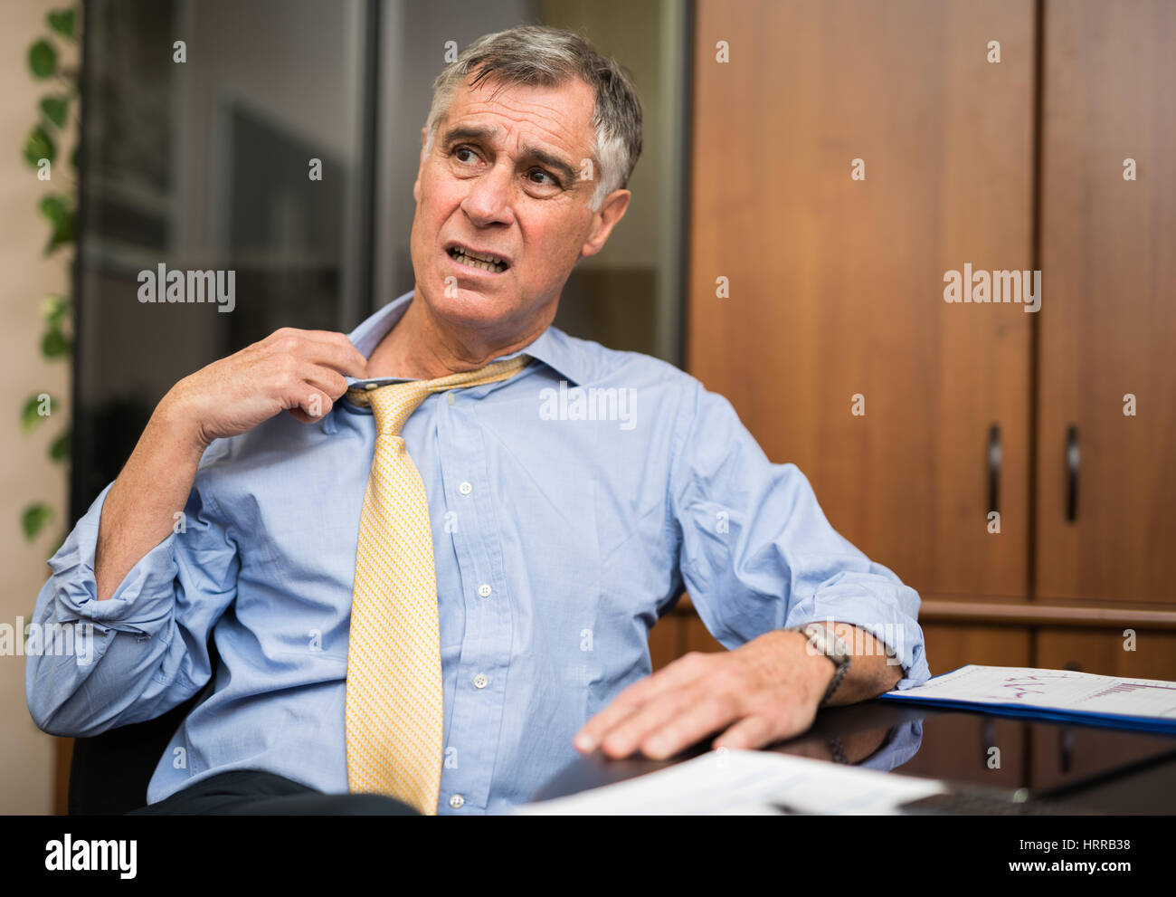 Businessman sweating in his office Stock Photo - Alamy