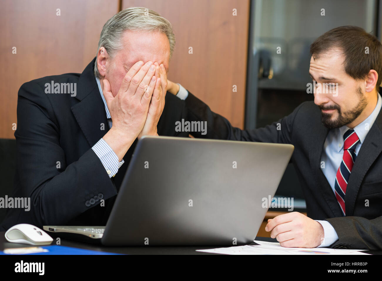 Businessman comforting his depressed and sad boss Stock Photo - Alamy