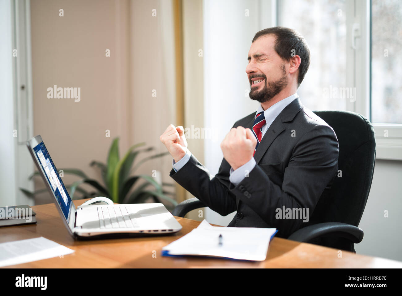 Very happy man in front of his laptop computer Stock Photo - Alamy