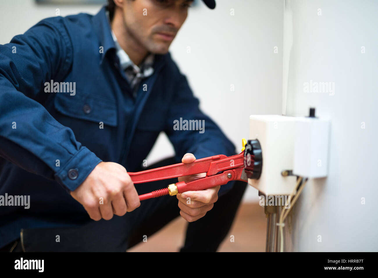 Technician using a wrench to tighten a fitting Stock Photo - Alamy
