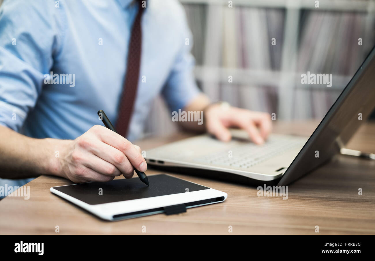Man using a graphics tablet in his studio Stock Photo - Alamy