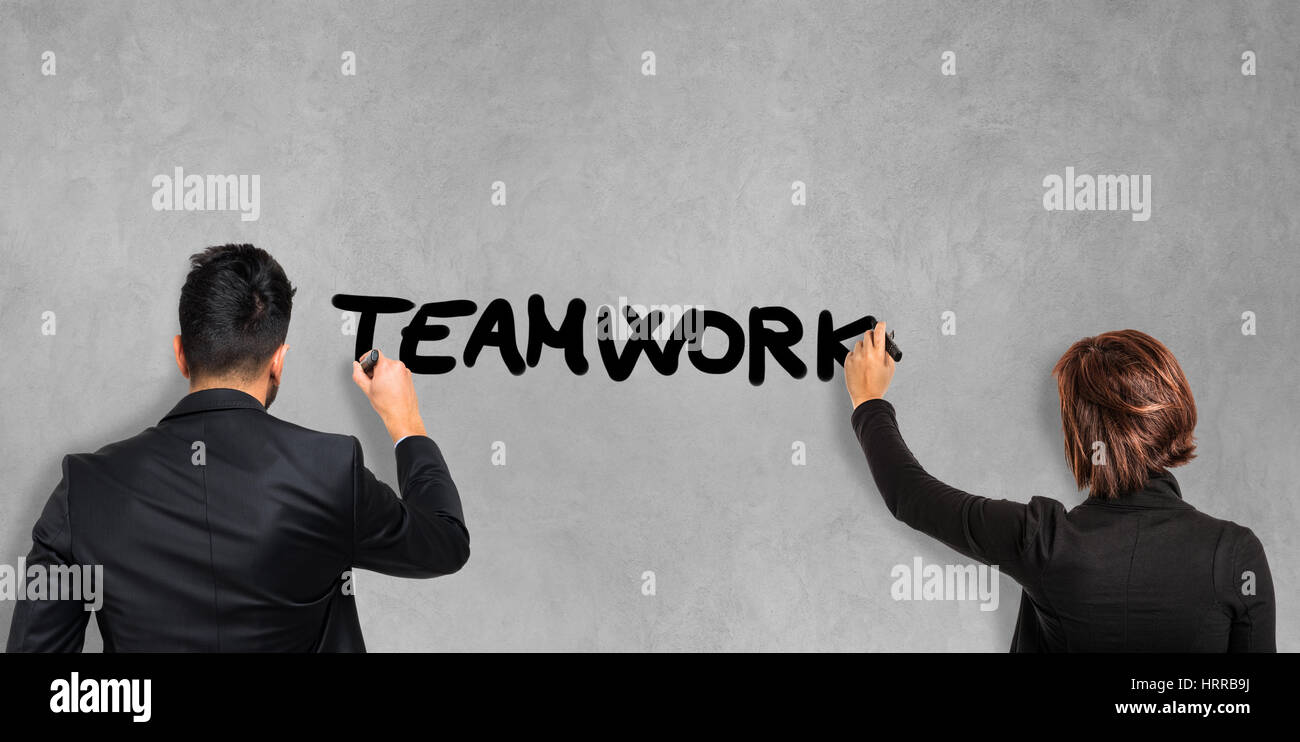 Business people writing the word Teamwork on the screen Stock Photo - Alamy