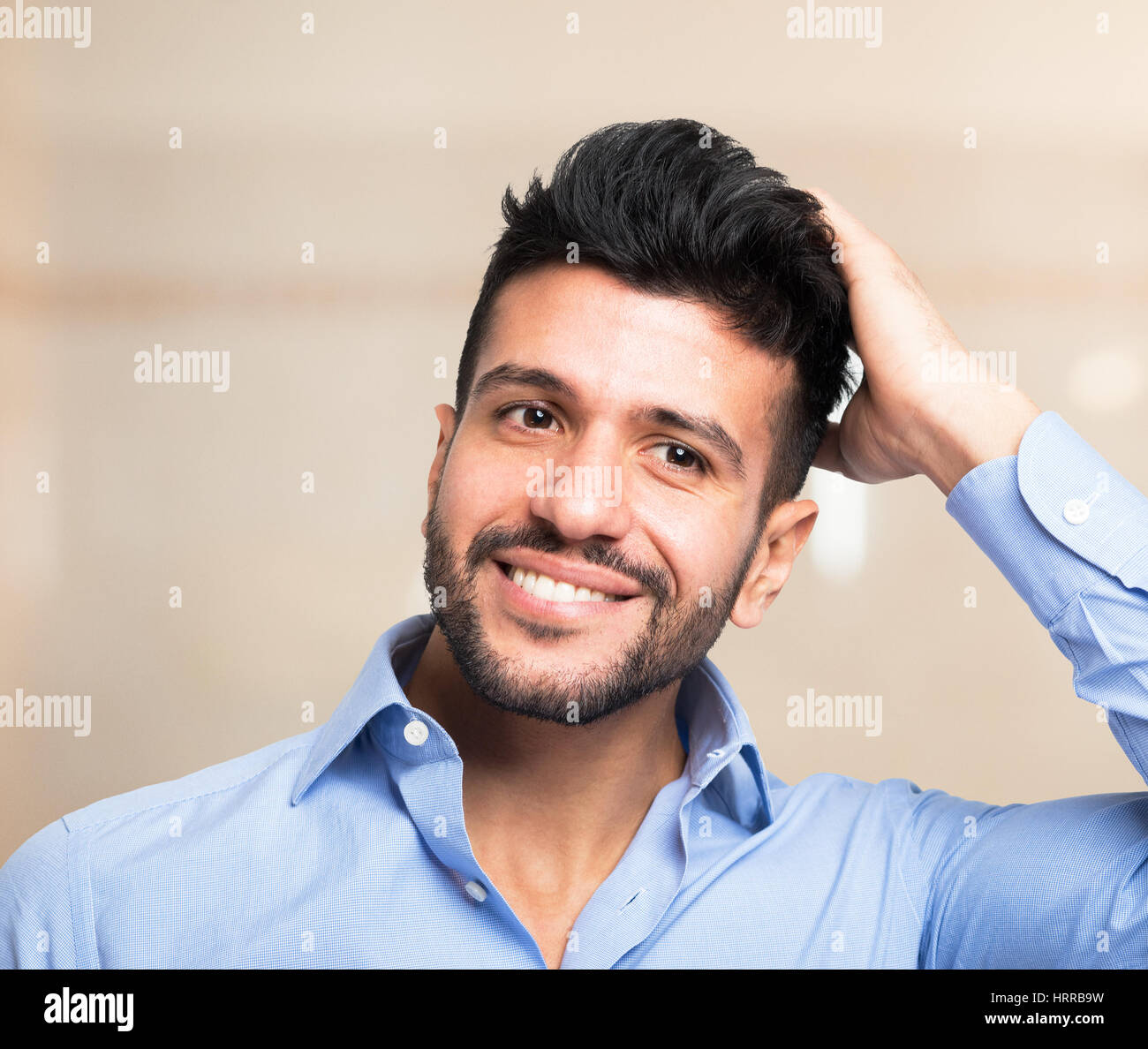 Happy man caressing his hair Stock Photo - Alamy
