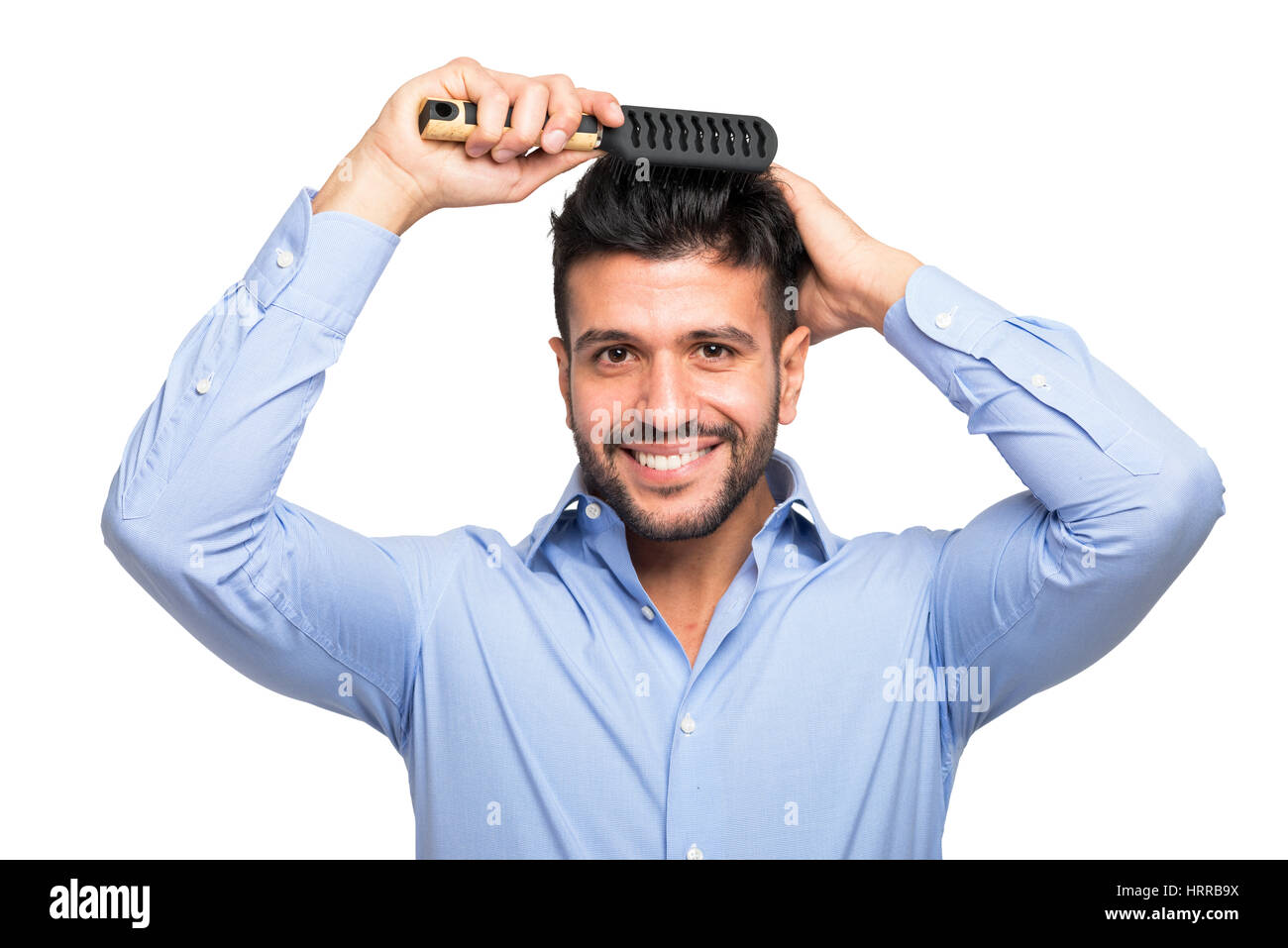 Portrait of a man combing his hair Stock Photo - Alamy