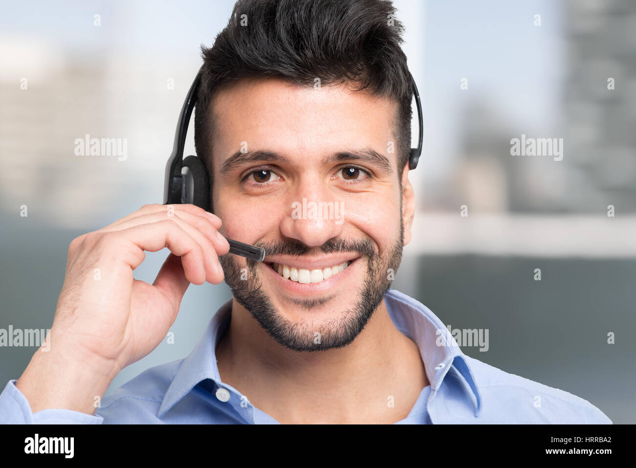 Smiling man using an headset Stock Photo - Alamy