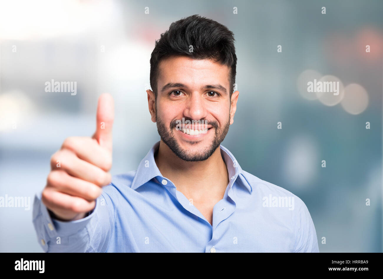 Portrait of a smiling business man giving thumbs up Stock Photo - Alamy