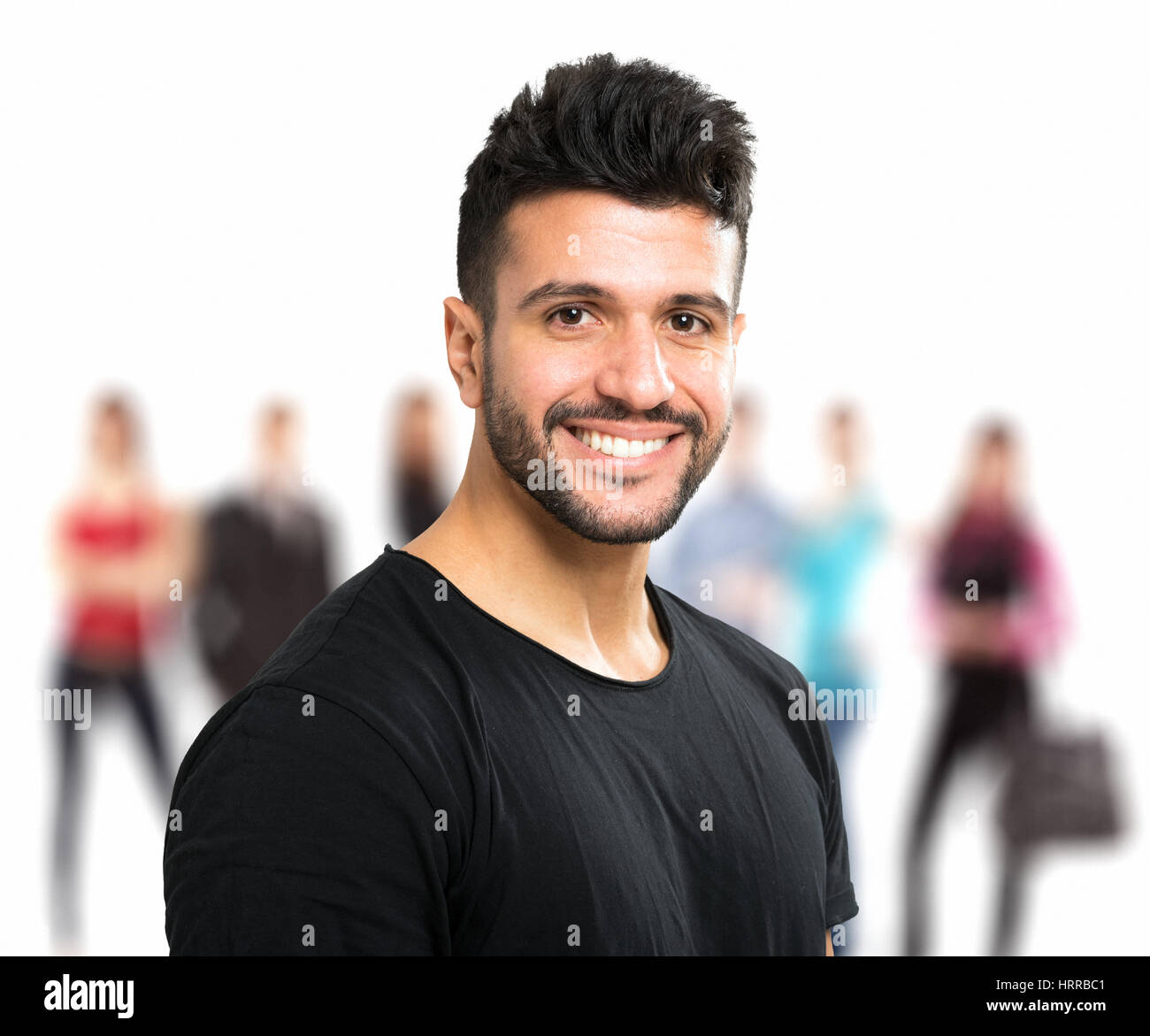 Portrait of a smiling young man in front of a group of people Stock ...