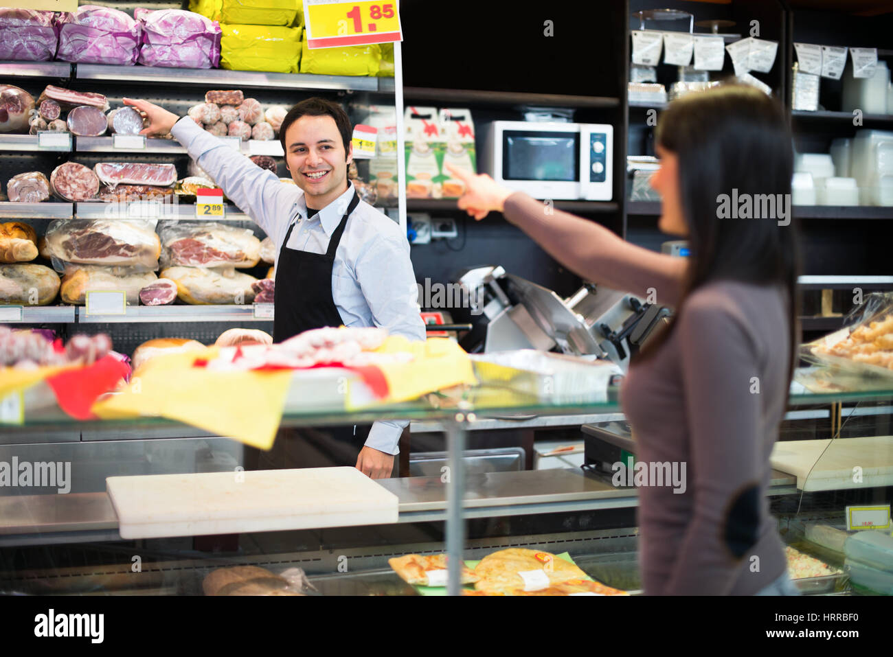Shopkeeper serving a customer in his grocery store Stock Photo - Alamy