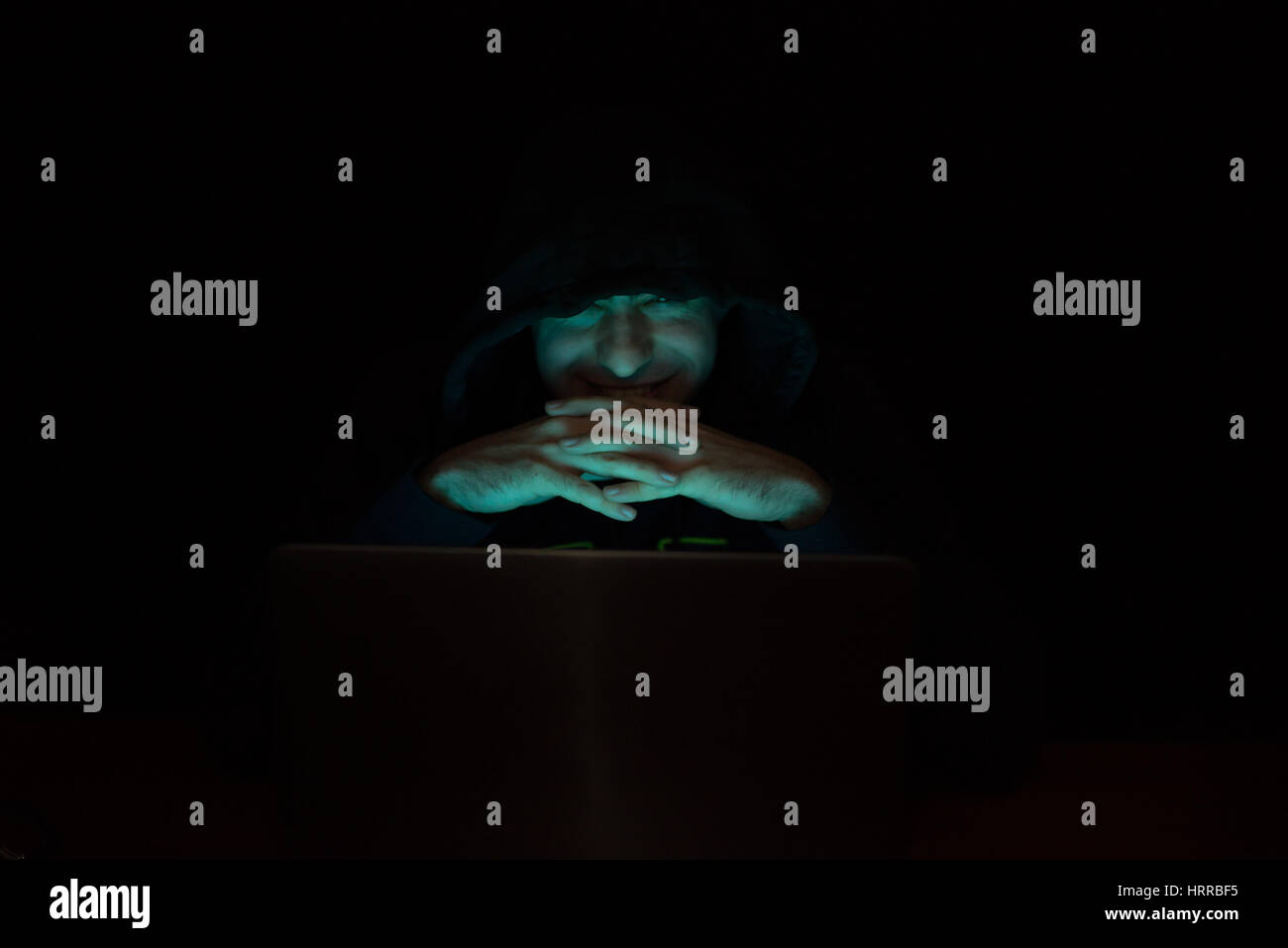 Hacker in front of his computer. Dark environment, monitor light Stock ...