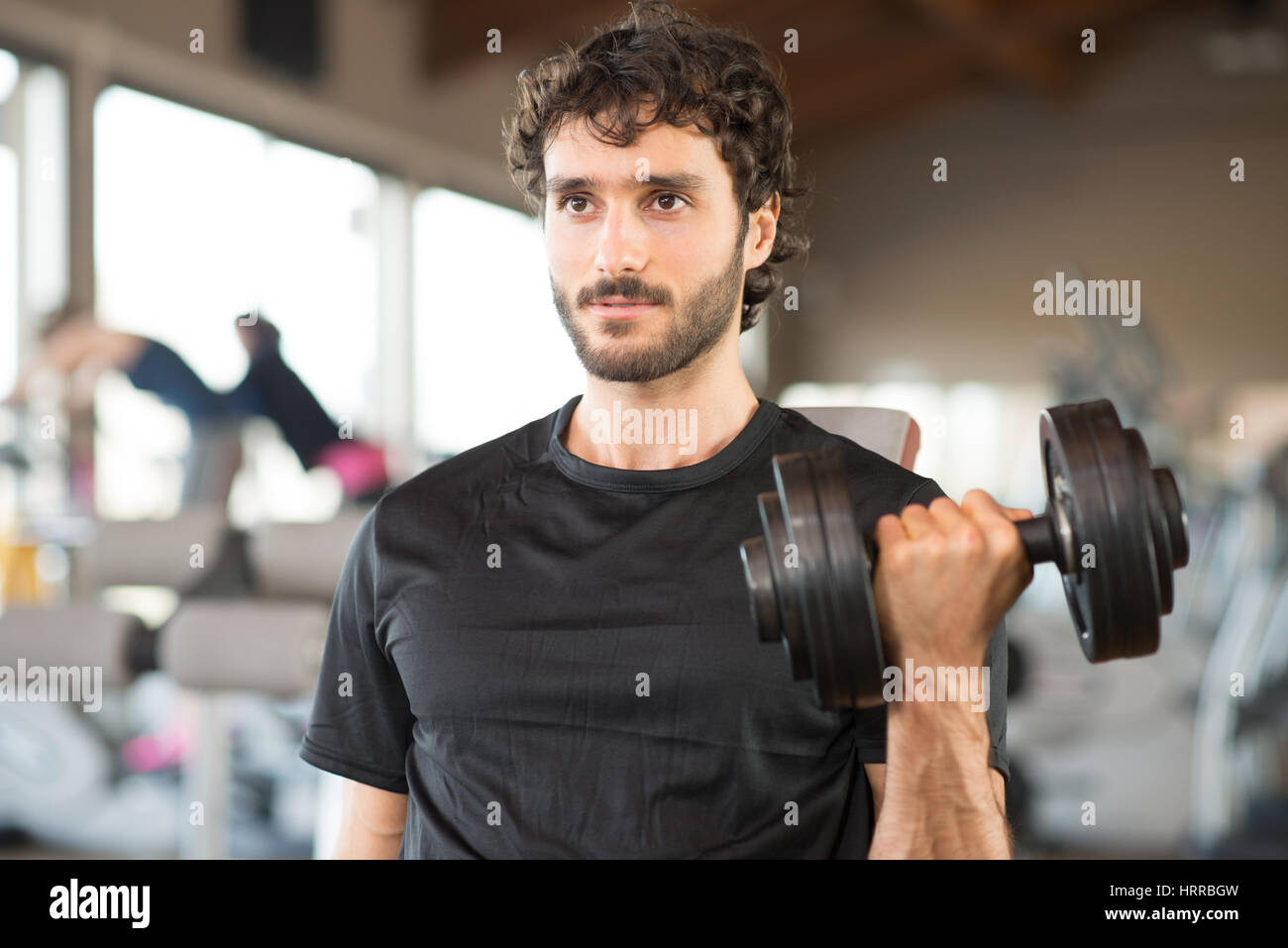 Man working out in a gym Stock Photo - Alamy