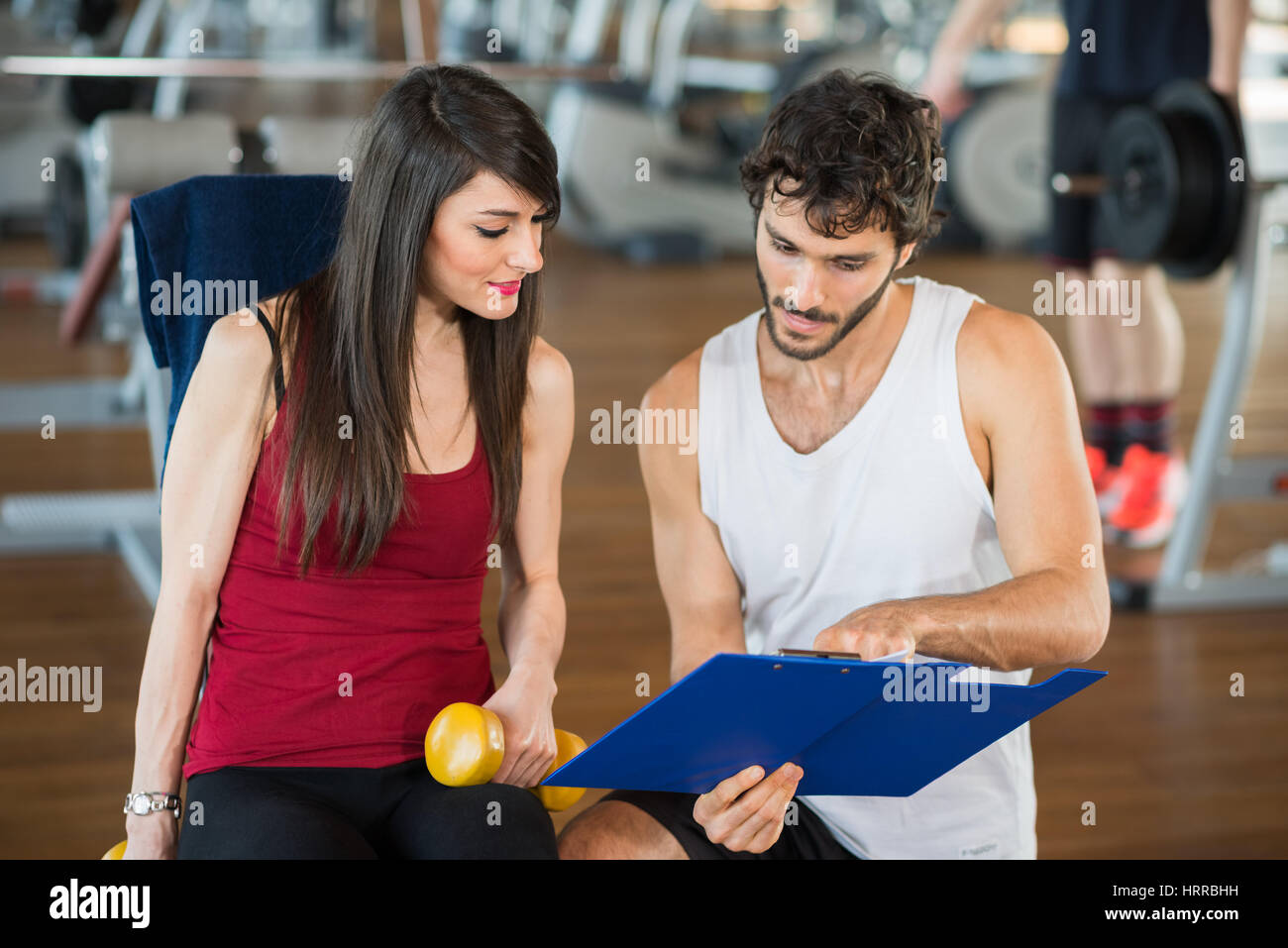 Woman in a gym reading her schedule Stock Photo - Alamy