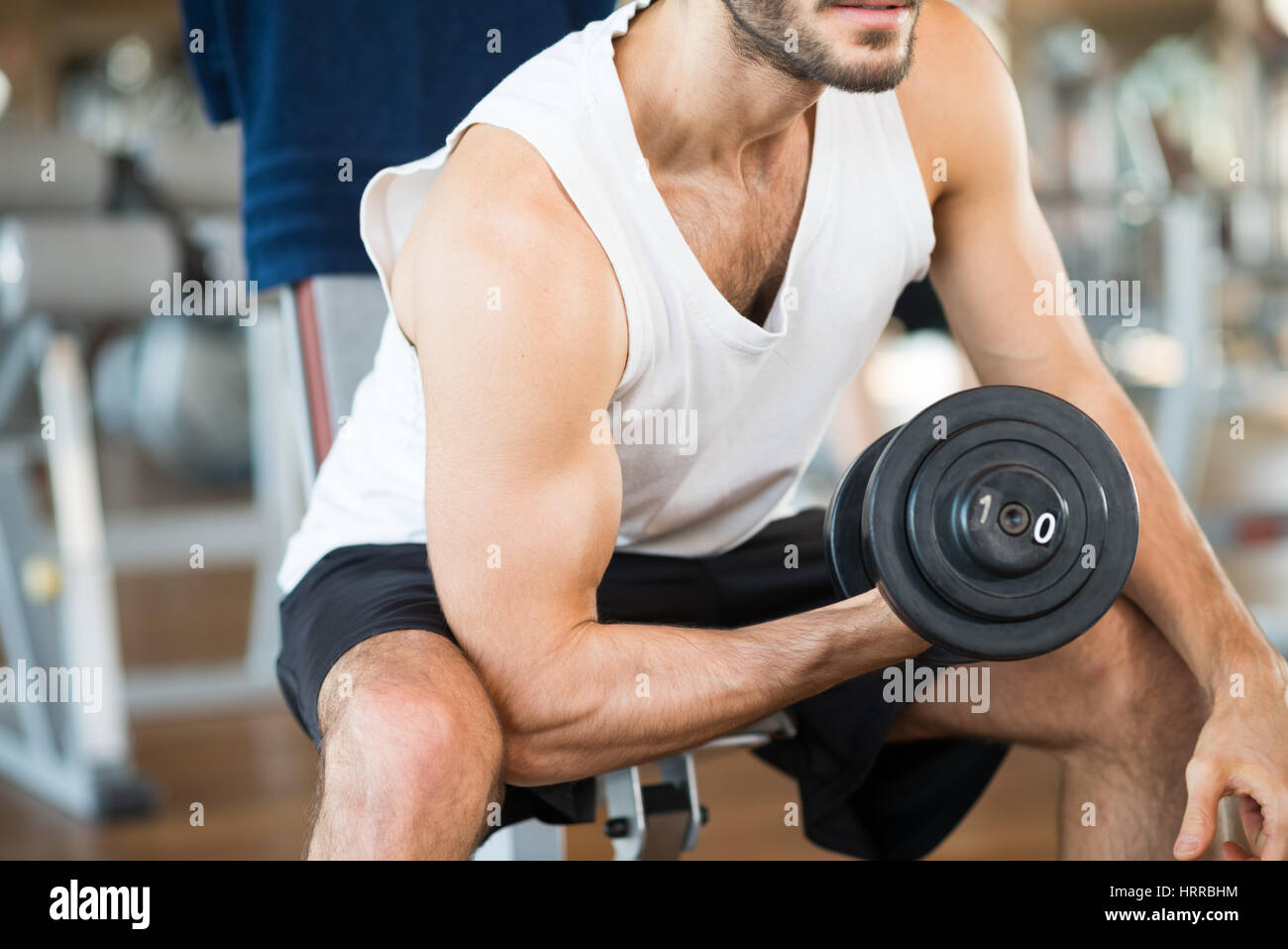 Bodybuilder using a dumbbell to work out Stock Photo - Alamy