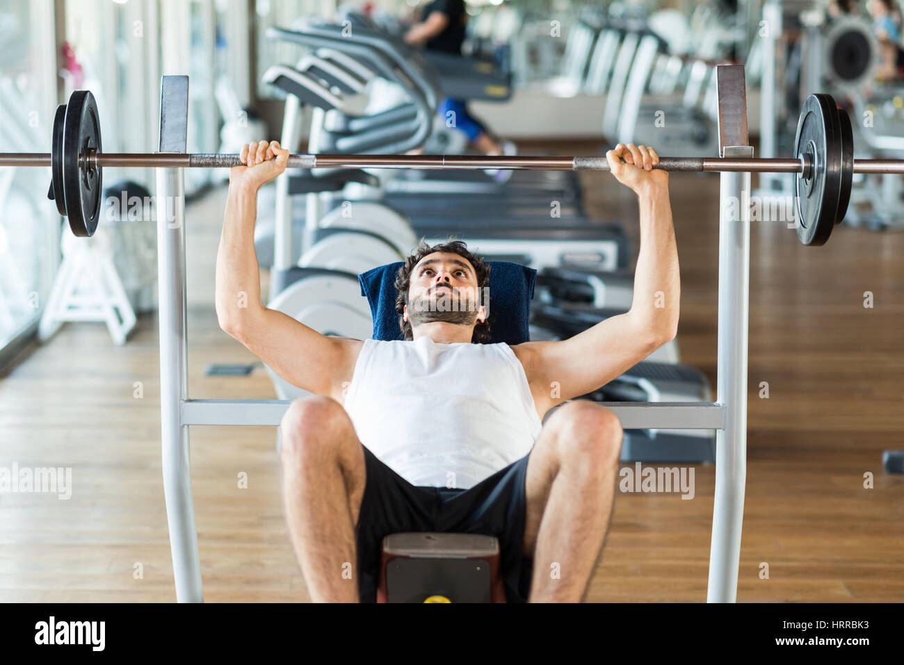 Man lifting a weight in a fitness club Stock Photo - Alamy