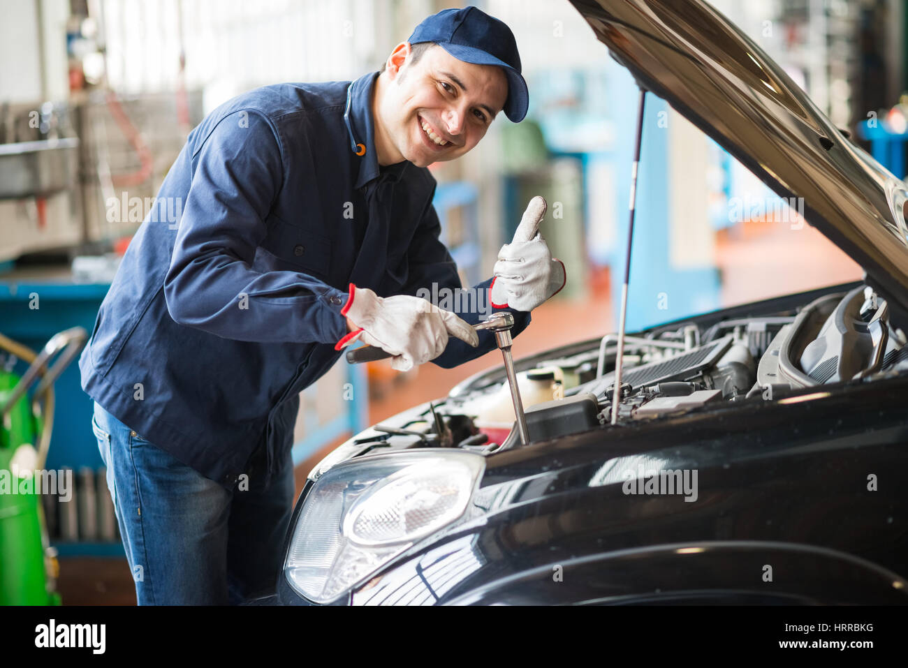 Smiling mechanic giving thumbs up Stock Photo - Alamy