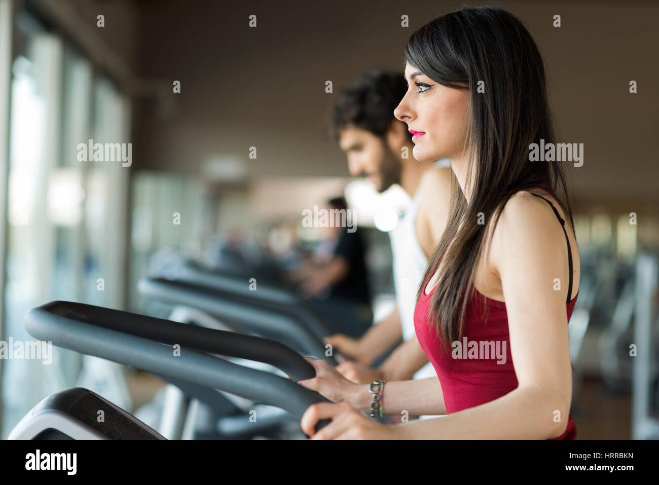 Woman running on a treadmill in a gym Stock Photo - Alamy