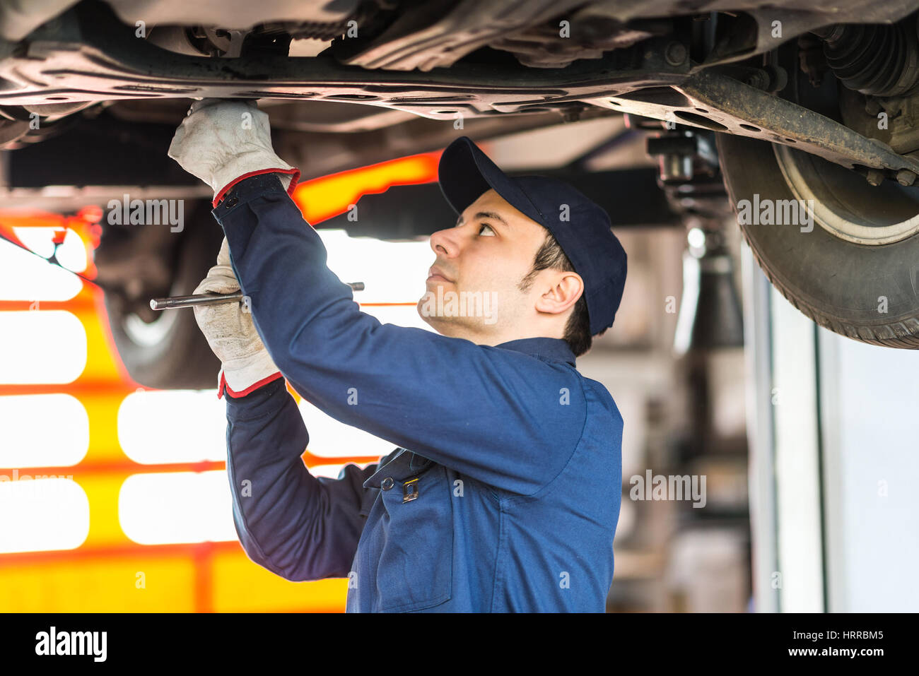 Portrait of a mechanic repairing a car in his garage Stock Photo - Alamy