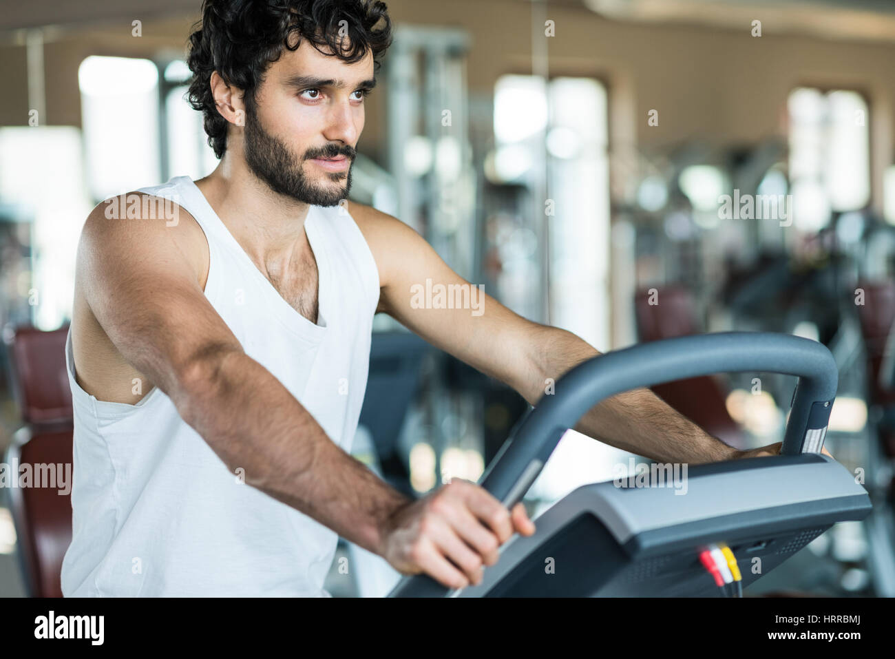 Handsome man working out in a gym Stock Photo - Alamy