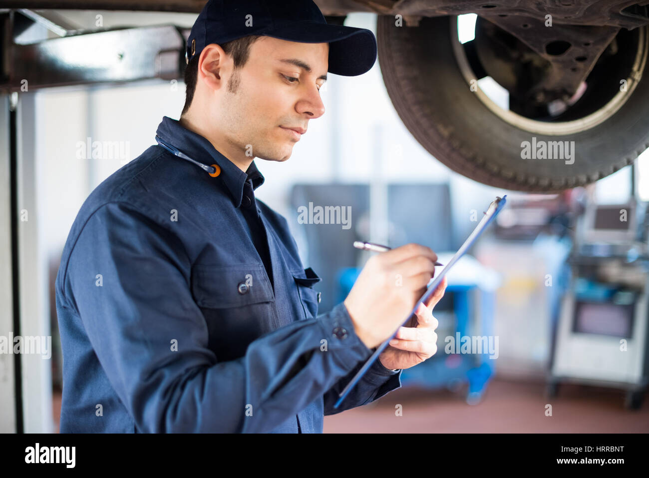Portrait of a mechanic at work in his garage Stock Photo - Alamy