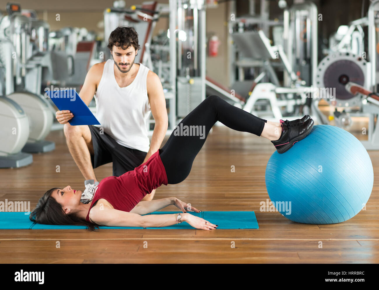 Smiling couple working out in a gym Stock Photo - Alamy