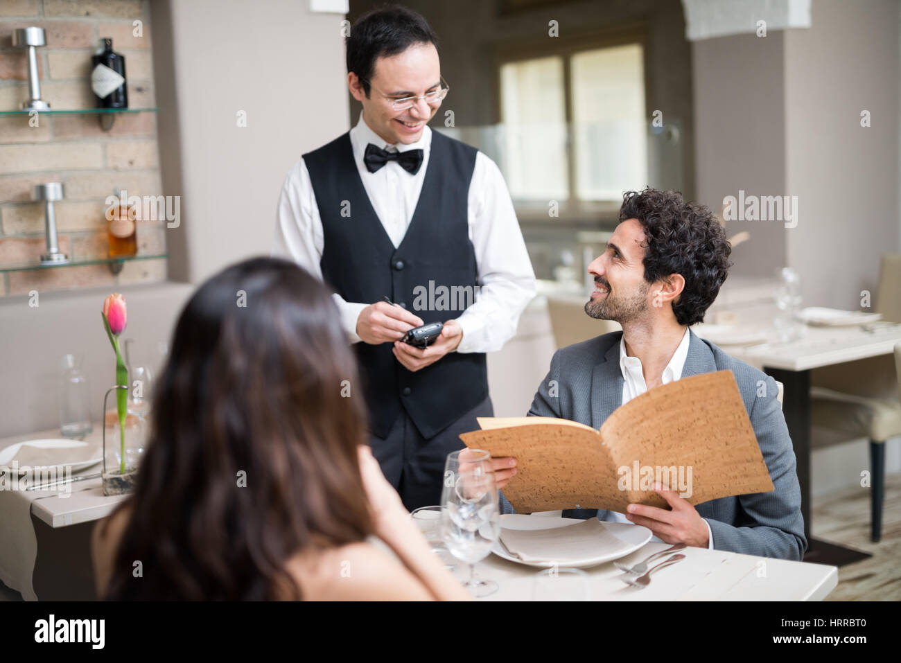 Couple ordering lunch in a restaurant Stock Photo - Alamy