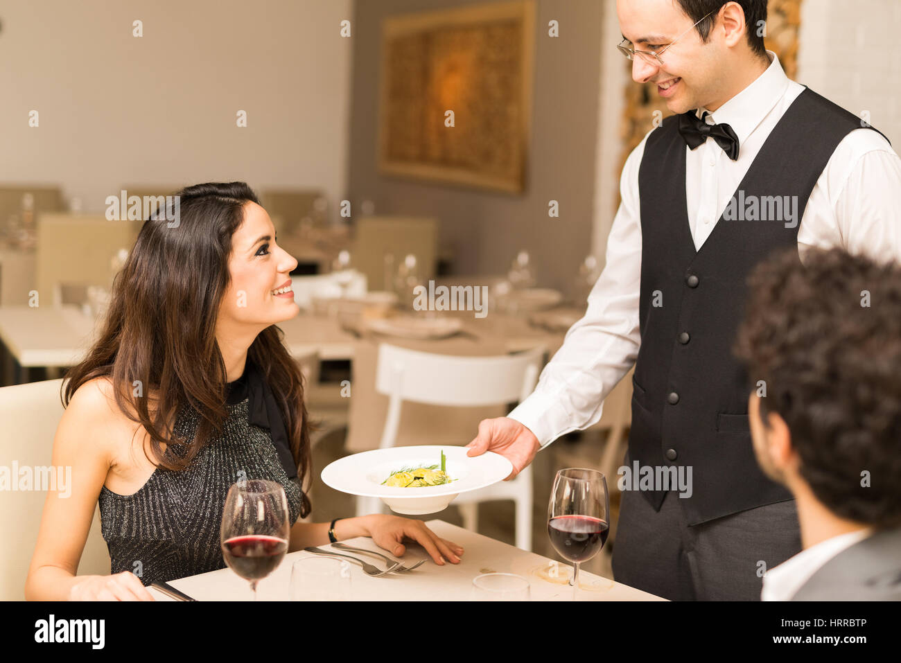 Waiter serving the dinner Stock Photo - Alamy