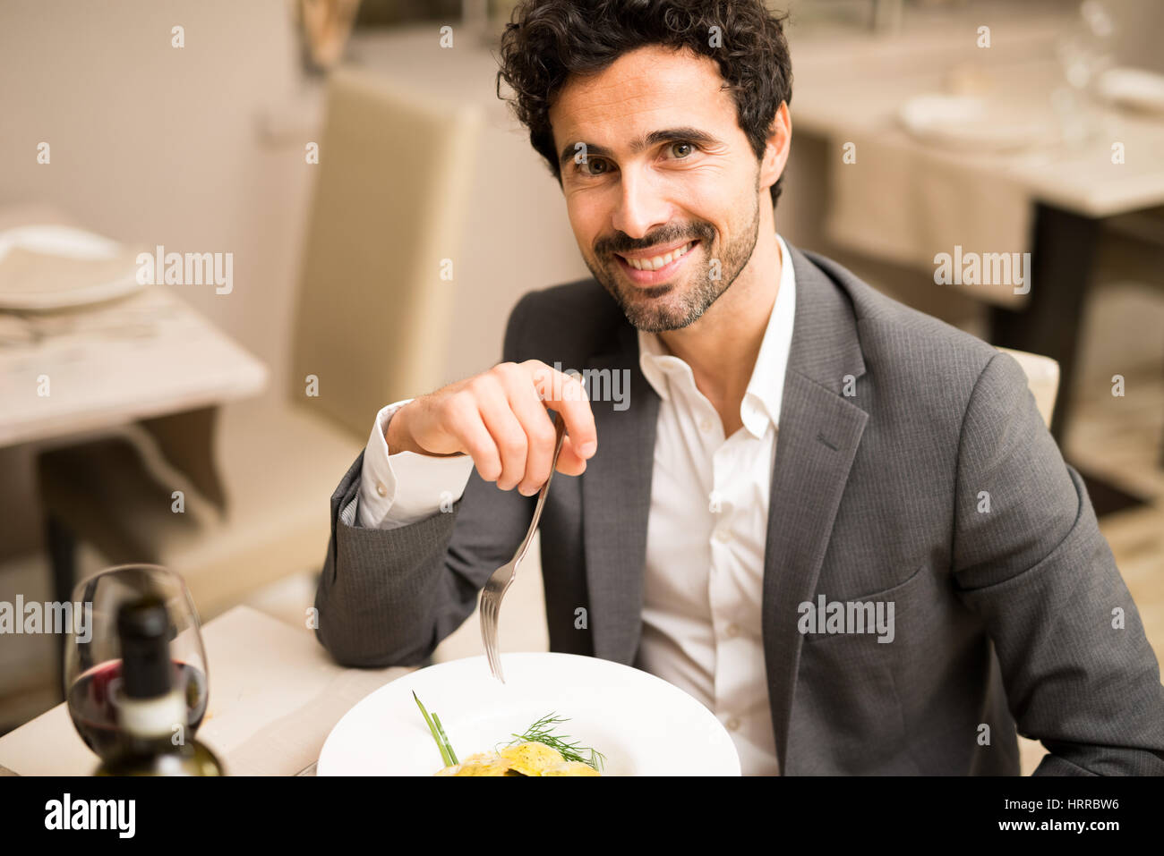 Handsome man eating at the restaurant Stock Photo - Alamy