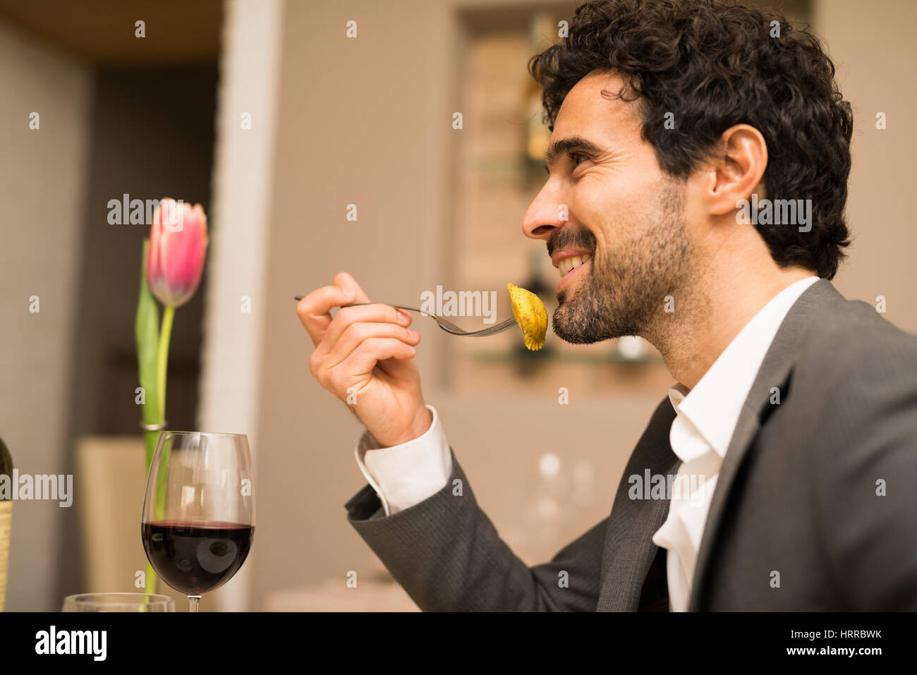 Man eating food at the restaurant Stock Photo - Alamy