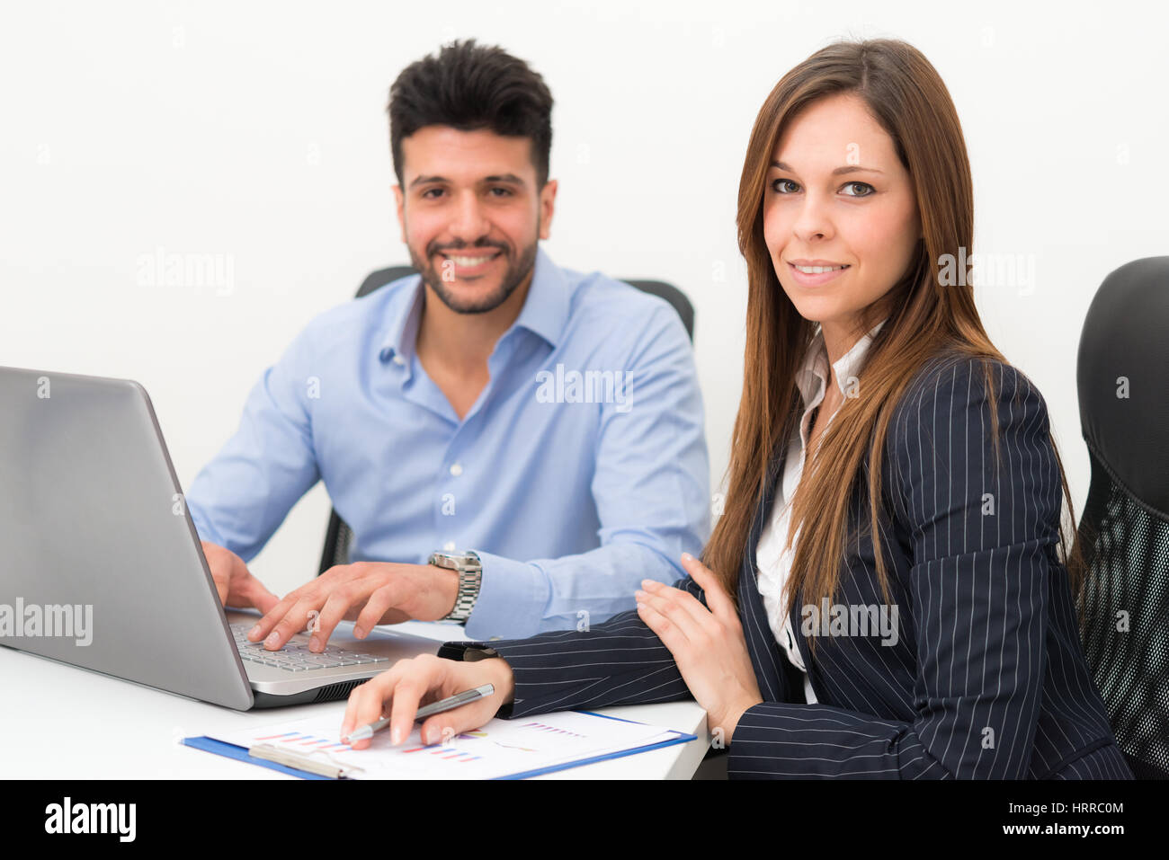 Business people using a laptop computer in their office Stock Photo - Alamy