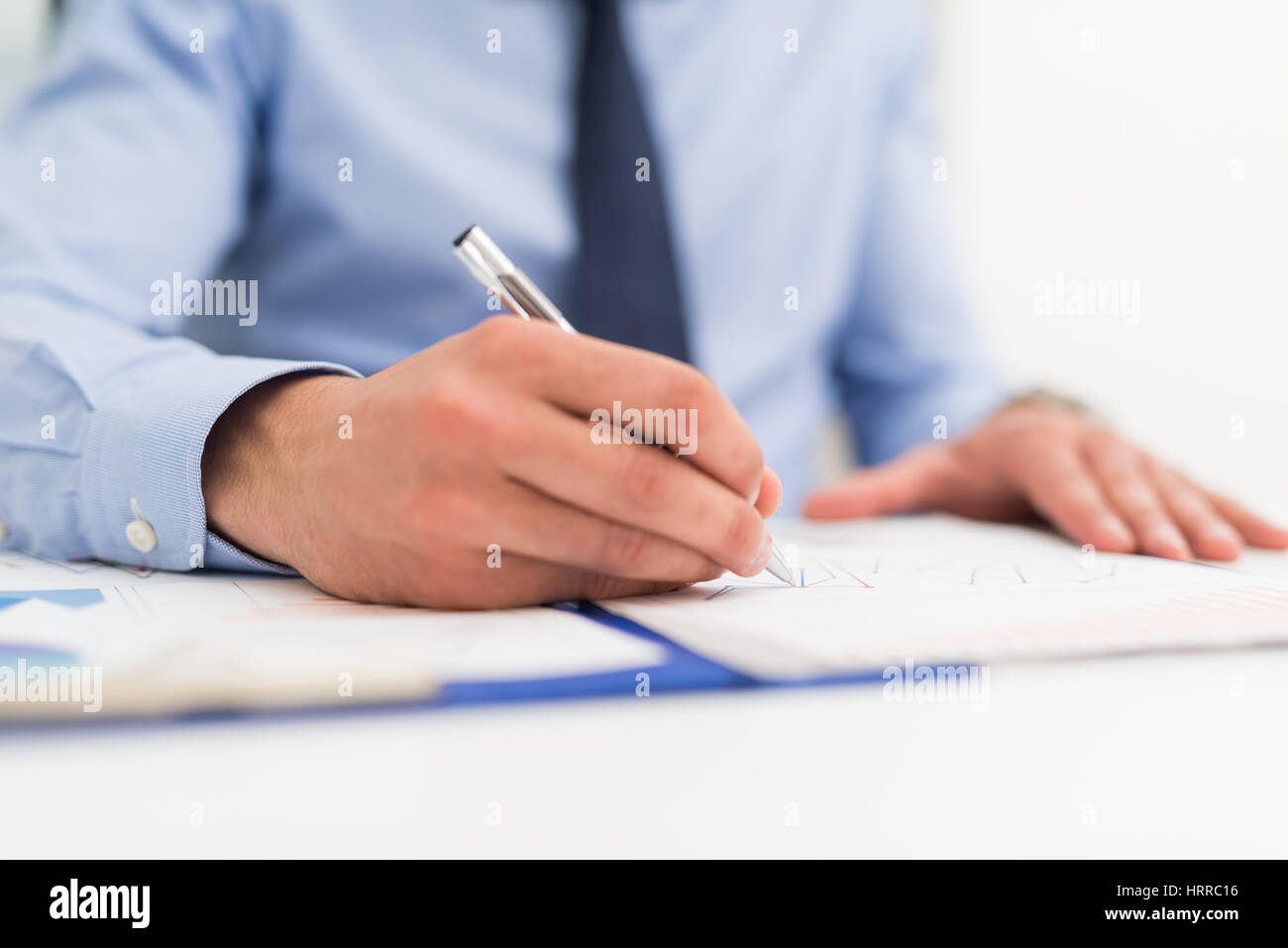 Detail of a businessman writing on a document Stock Photo - Alamy