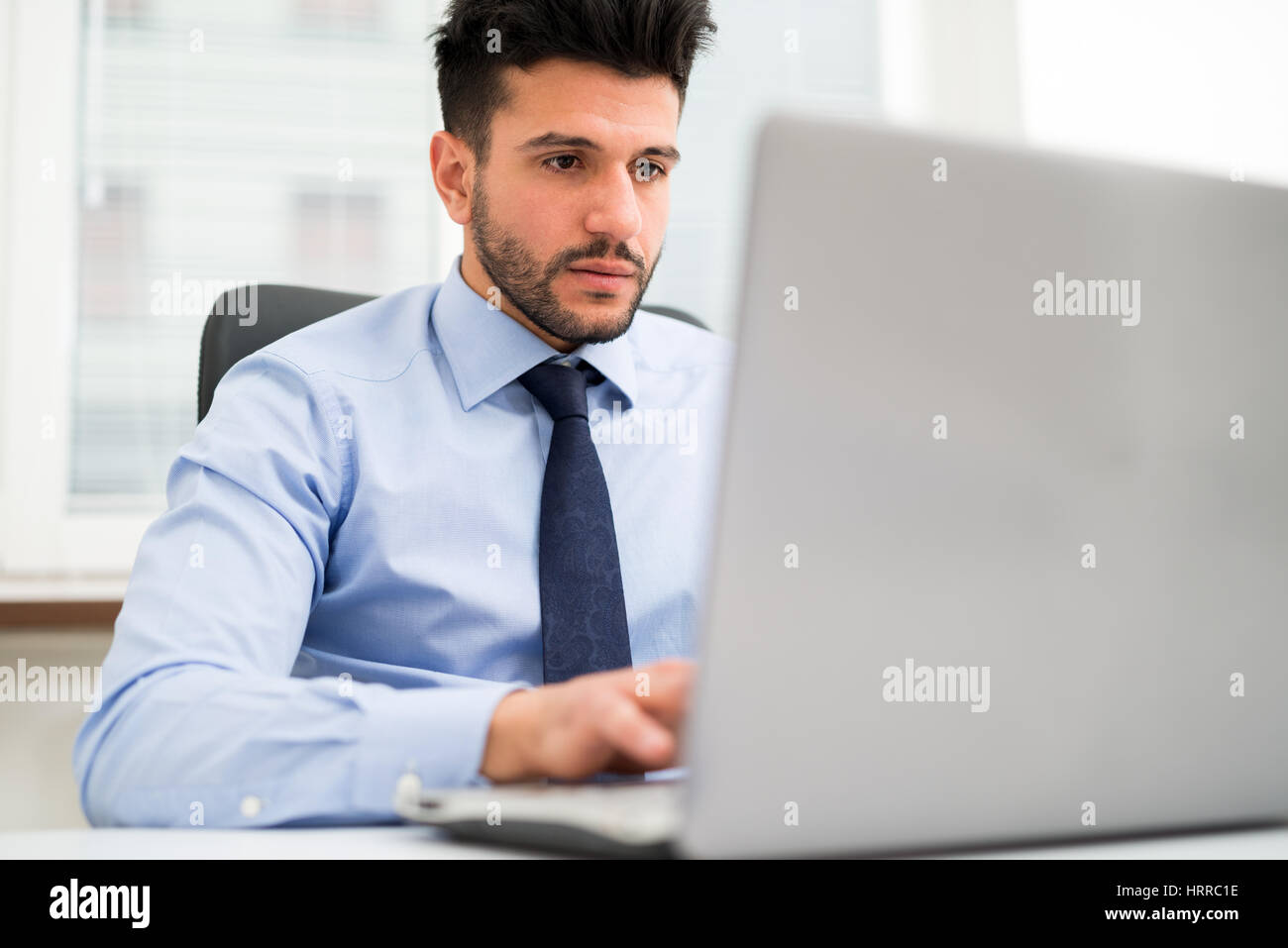 Businessman using a laptop Stock Photo - Alamy