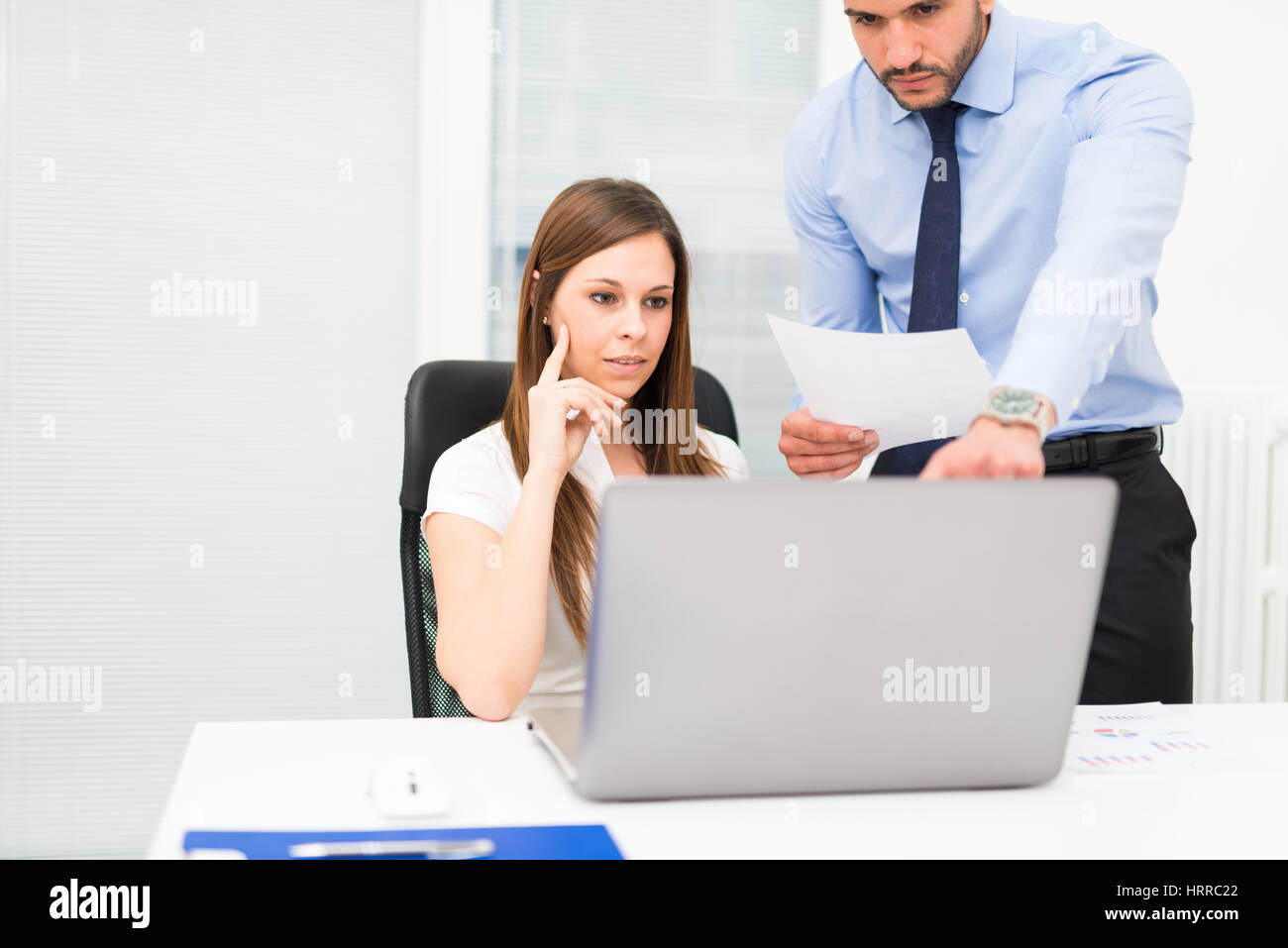 Business people using a laptop computer in their office Stock Photo - Alamy