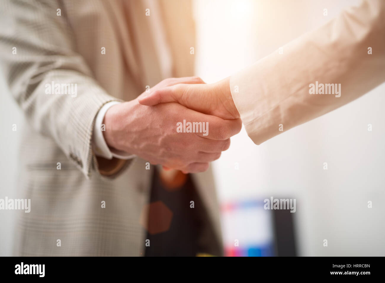 Business people shaking their hands. Lens flare effect Stock Photo - Alamy