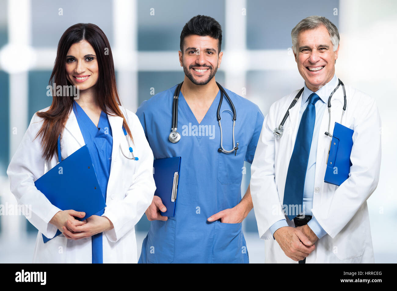 Group of smiling doctors. Bright blurred background Stock Photo - Alamy