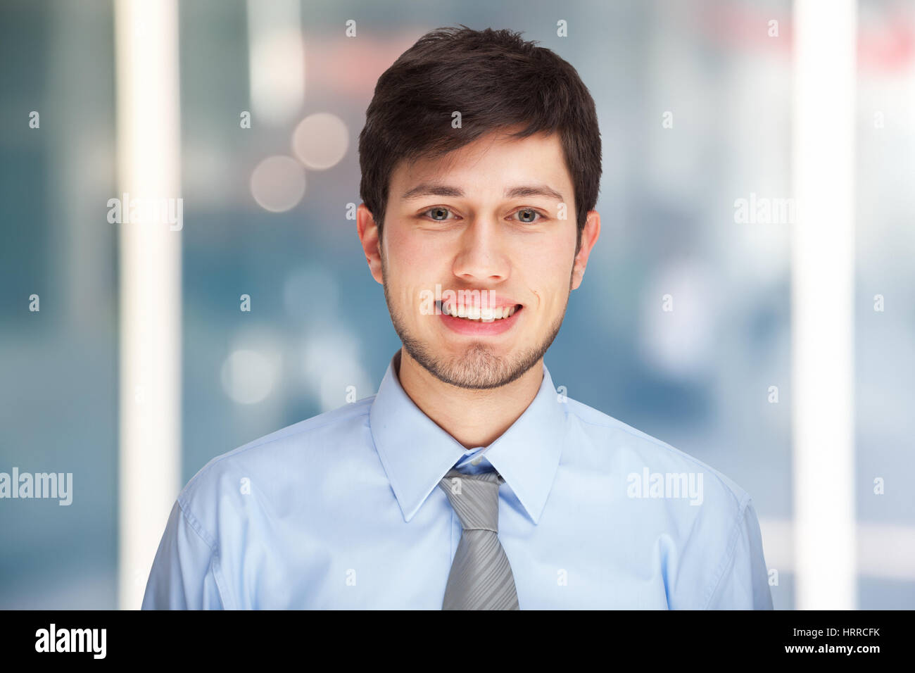 Portrait of a young smiling businessman Stock Photo - Alamy