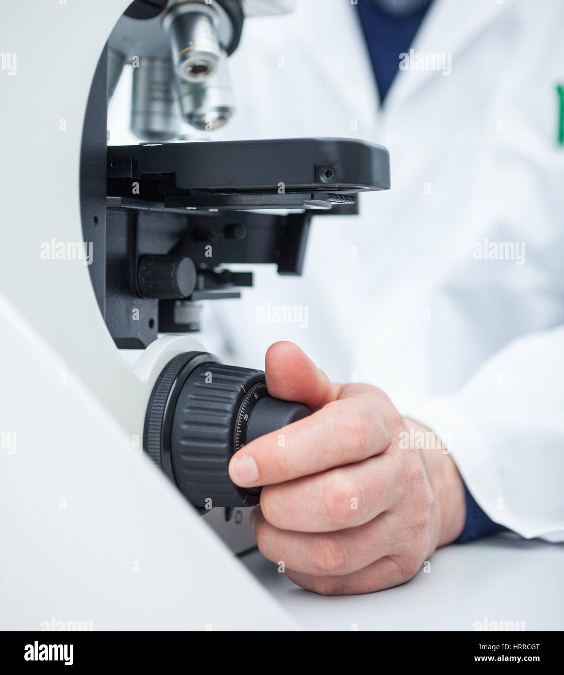 Researcher using a microscope Stock Photo - Alamy