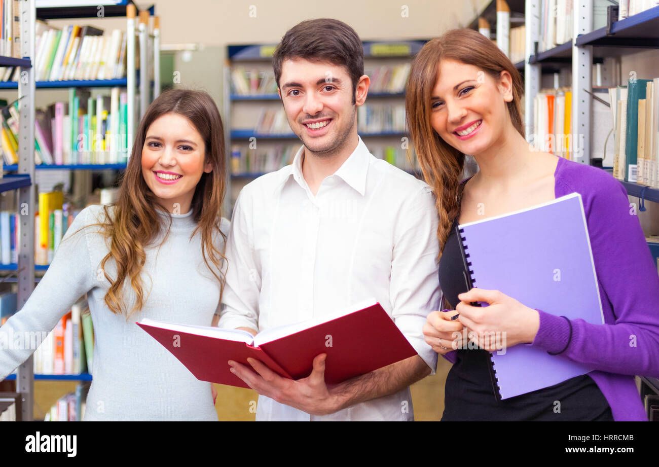 Smiling students in the university library Stock Photo - Alamy