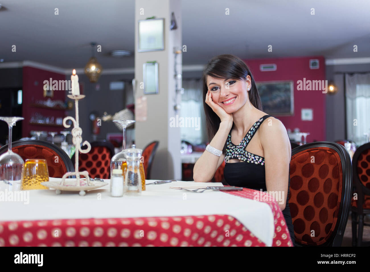 Woman waiting in a restaurant Stock Photo - Alamy