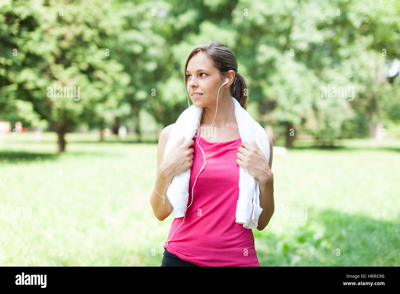 Active woman relaxing after running in a park Stock Photo - Alamy