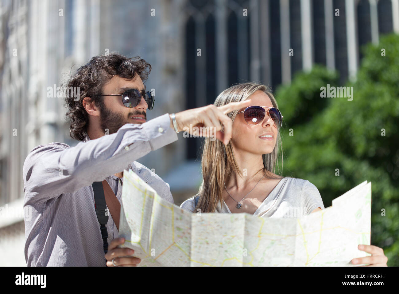 Two young tourists checking map hi-res stock photography and images - Alamy